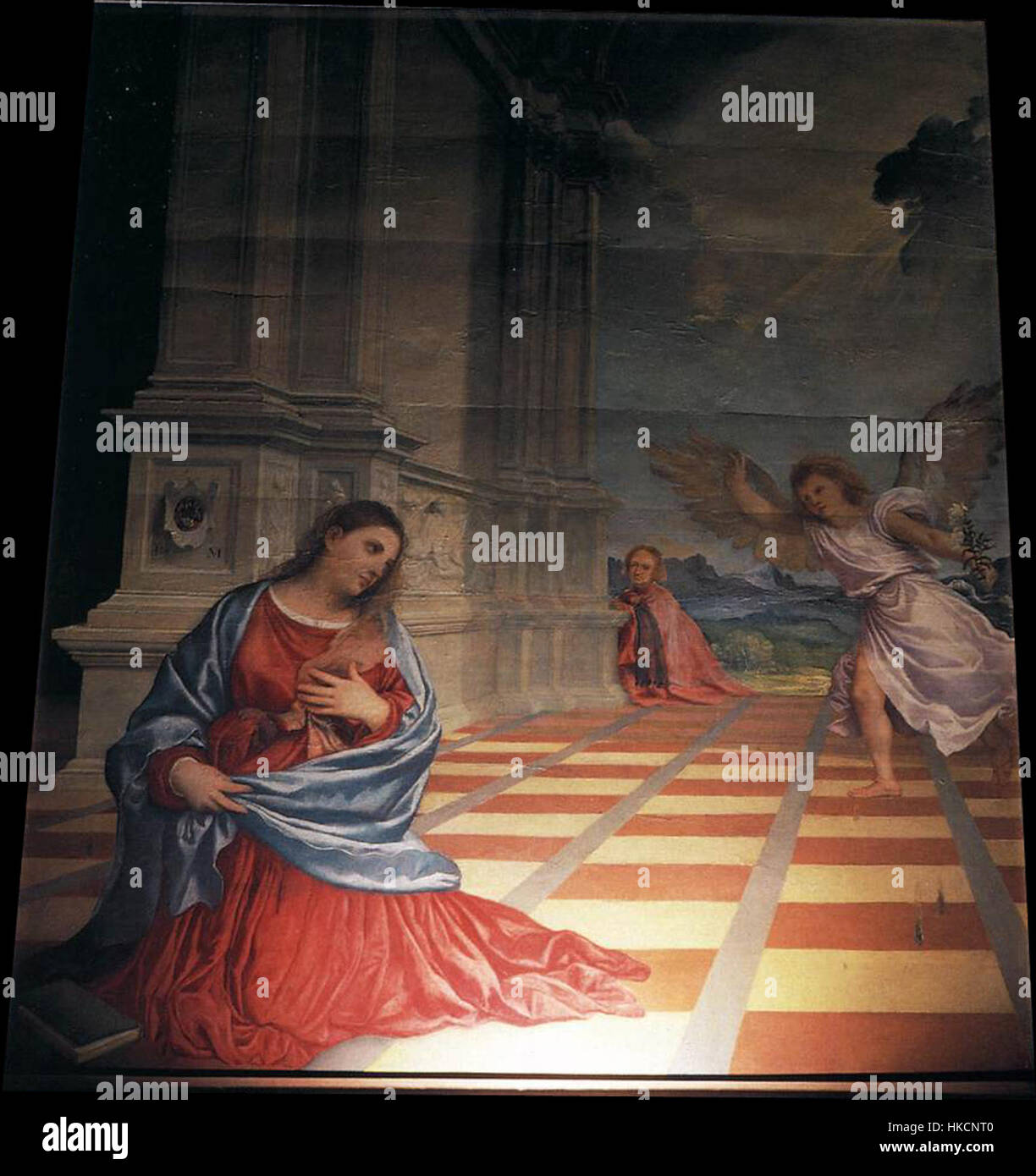 This artwork, attributed to Titian, features the Annunciation, with a ...