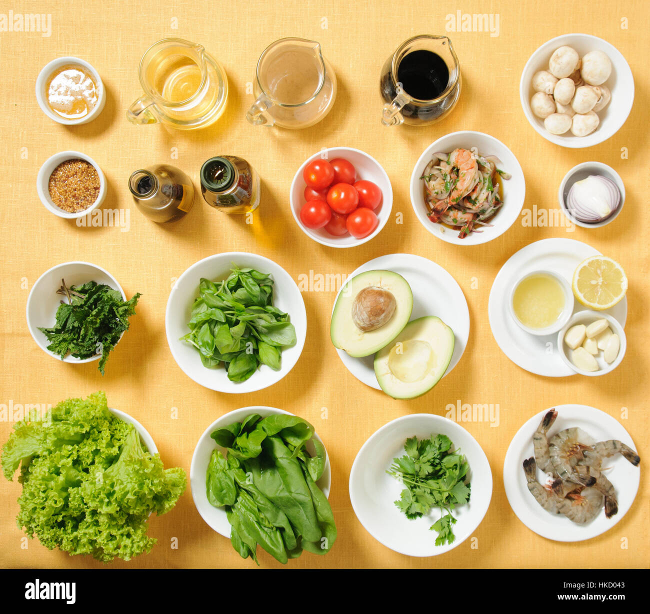 Ingredients for salad in separate plates on yellow background Stock ...