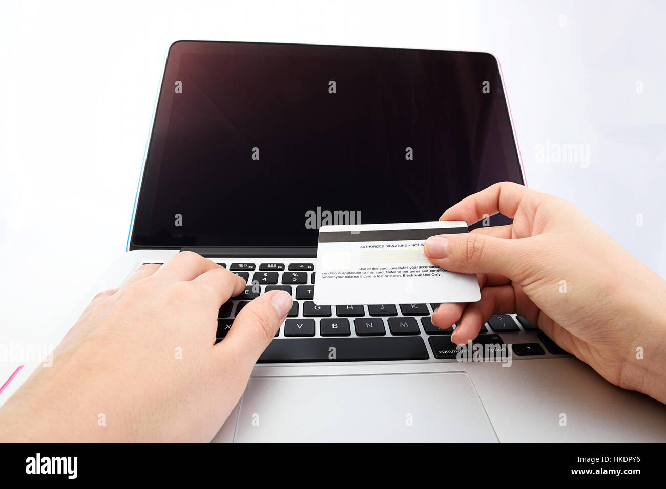 view from eye level of Human next to laptop with credit card on white ...