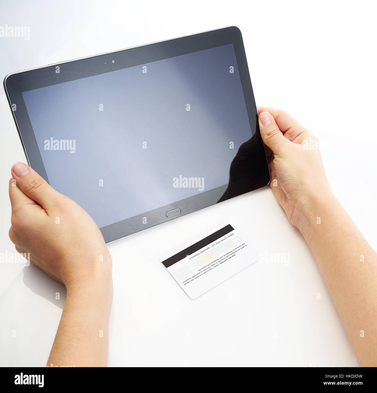 Buying with credit card via tablet on white background Stock Photo - Alamy