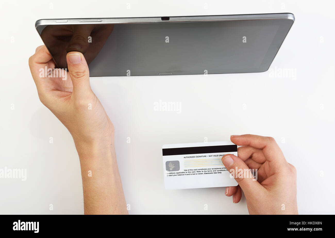 Buying with credit card via tablet on white background Stock Photo - Alamy