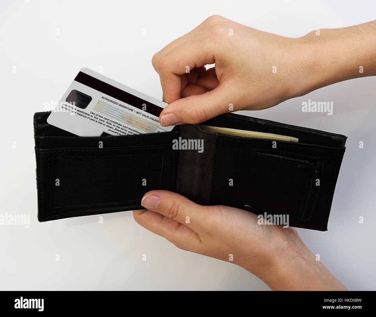 Person taking credit card from black wallet on white backdrop Stock ...