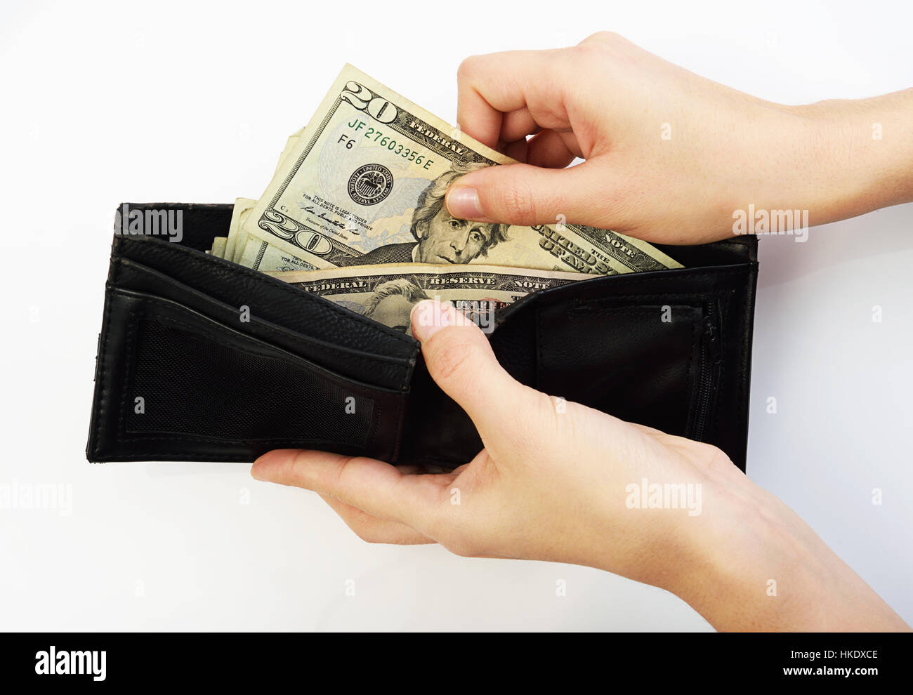 Person taking twenty dollars money from black wallet Stock Photo - Alamy