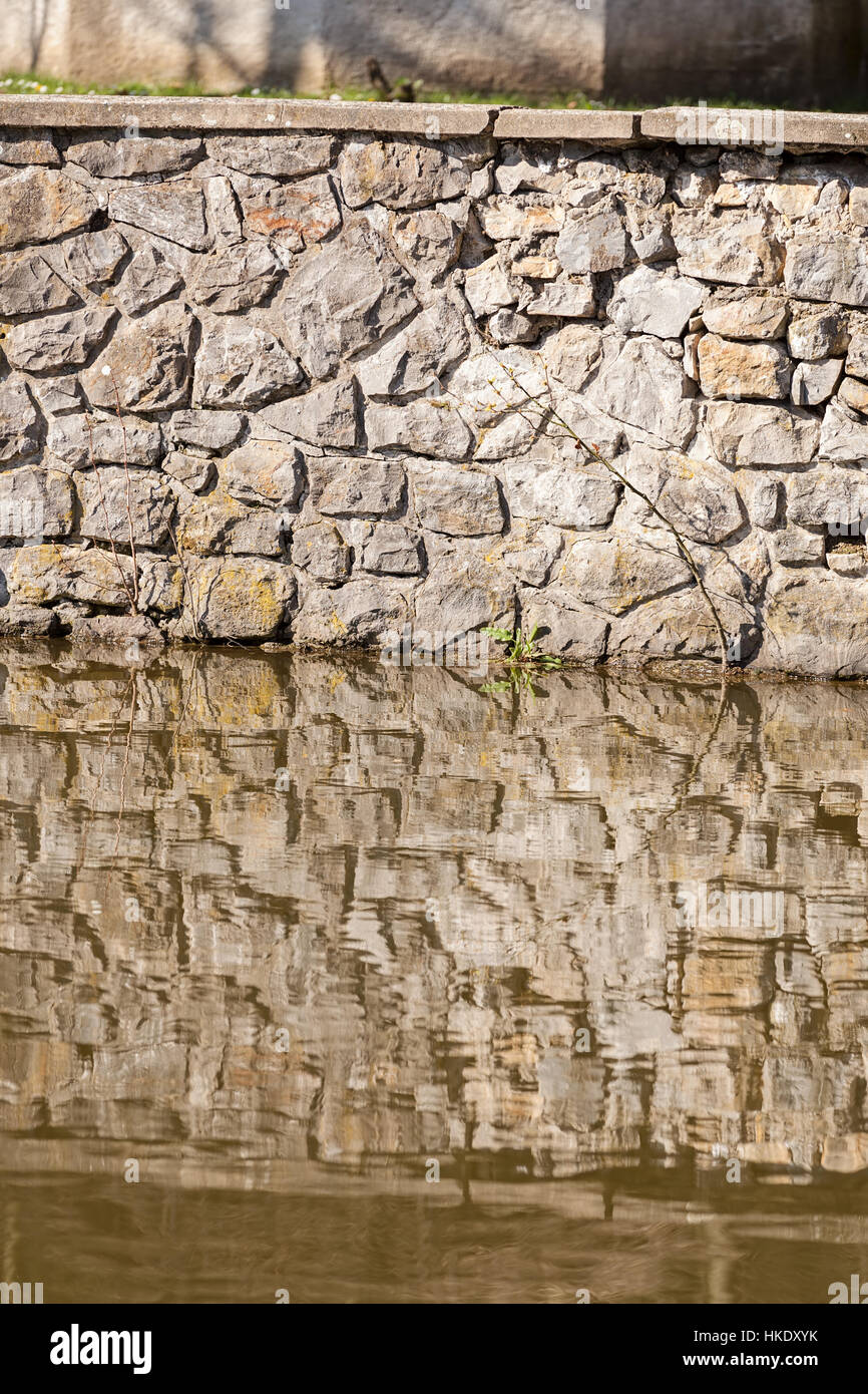 wall of stone above water, note shallow depth of field Stock Photo - Alamy