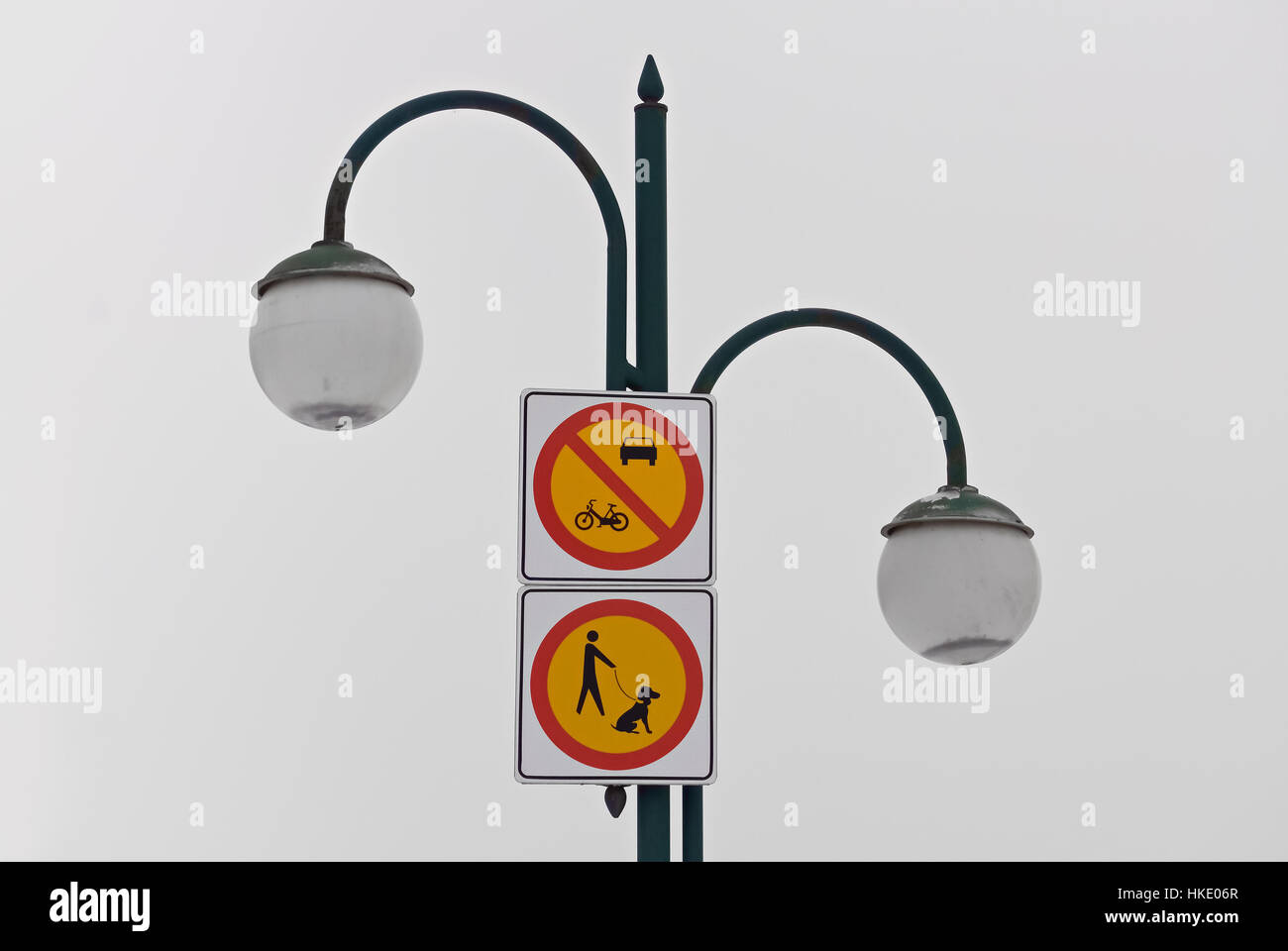 Two restriction signs for motorized vehicles and animals on a lamp post ...