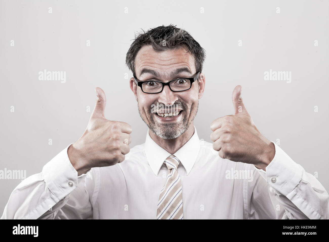Happy smiling man hold up thumbs of both hands Stock Photo - Alamy