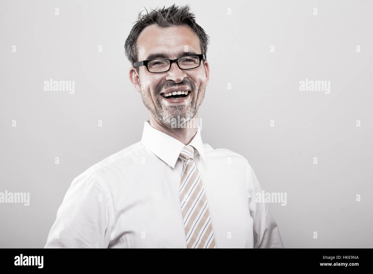 Man in formal wear with tie happily smiles Stock Photo - Alamy