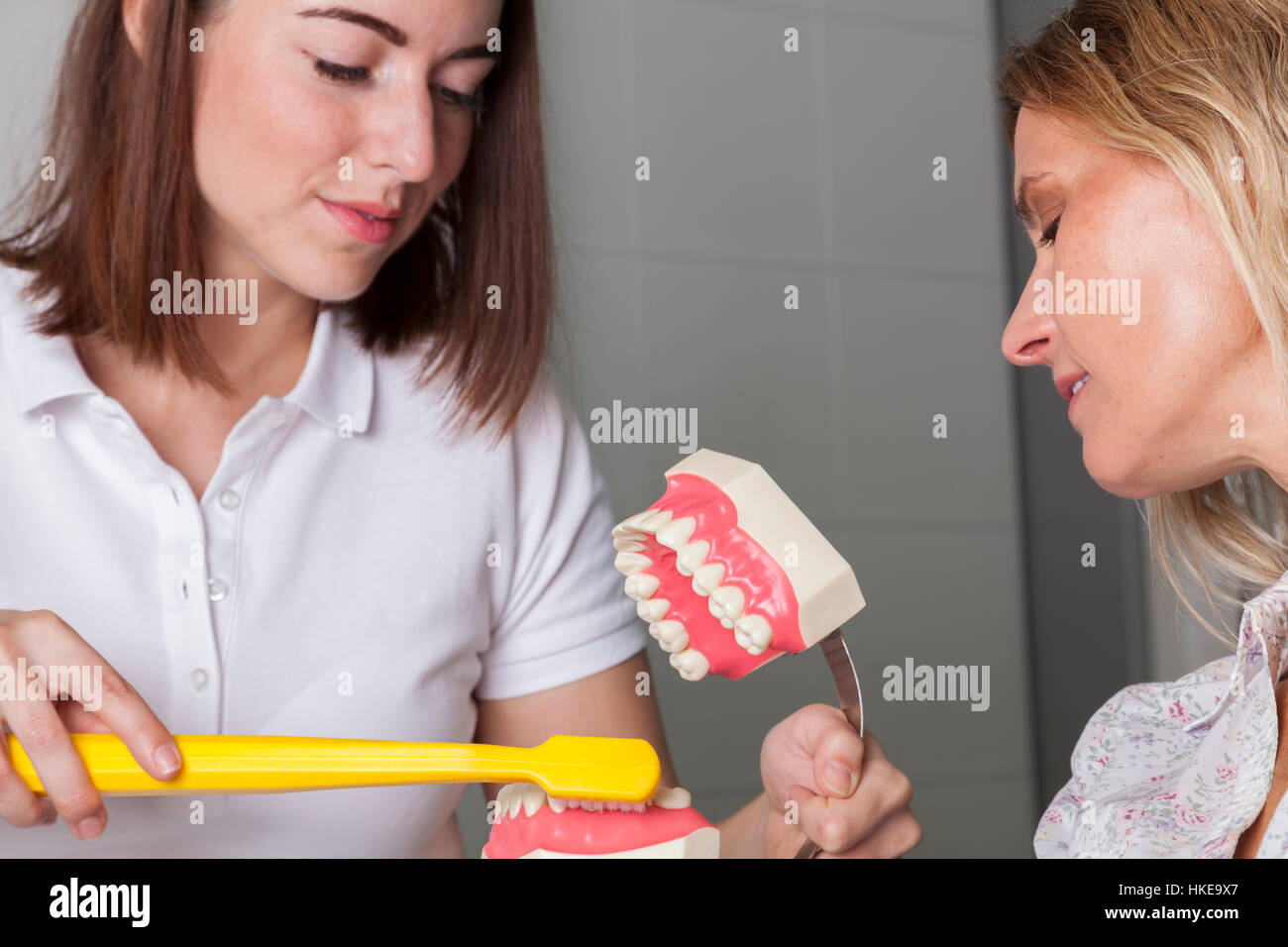 dentist and assistant introduce patient to the treatment Stock Photo ...