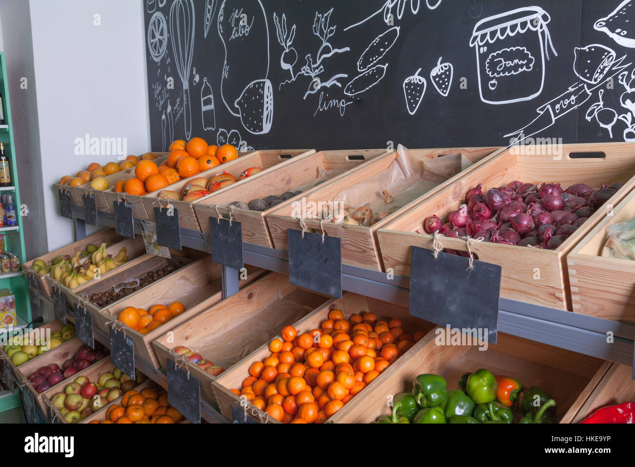 Fruits and vegetables presented in a green grocer store in wooden ...