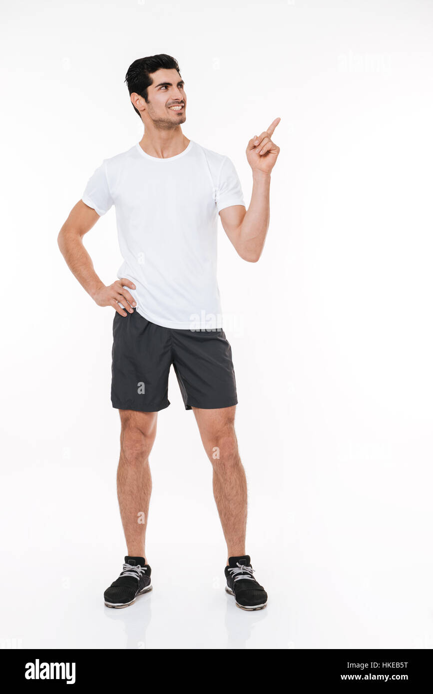 Full length portrait of a happy smiling sports man standing and ...