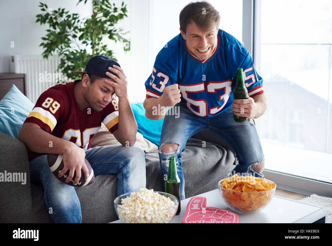 Two people supporting different team hi-res stock photography and ...