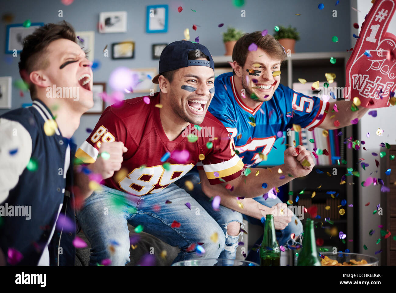American football fans among falling confetti Stock Photo - Alamy