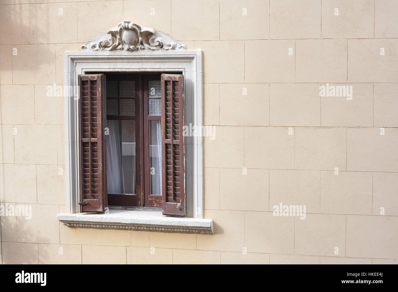 Classical window with timbre shutters on yellow wall in Spain Stock ...
