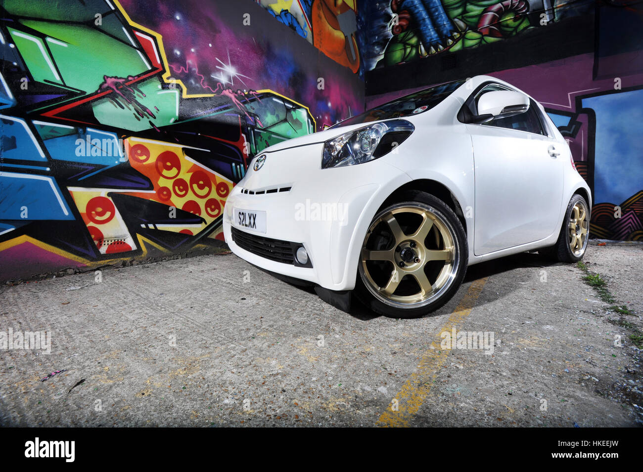 Modified Toyota IQ sub compact city car and graffiti wall Stock Photo ...