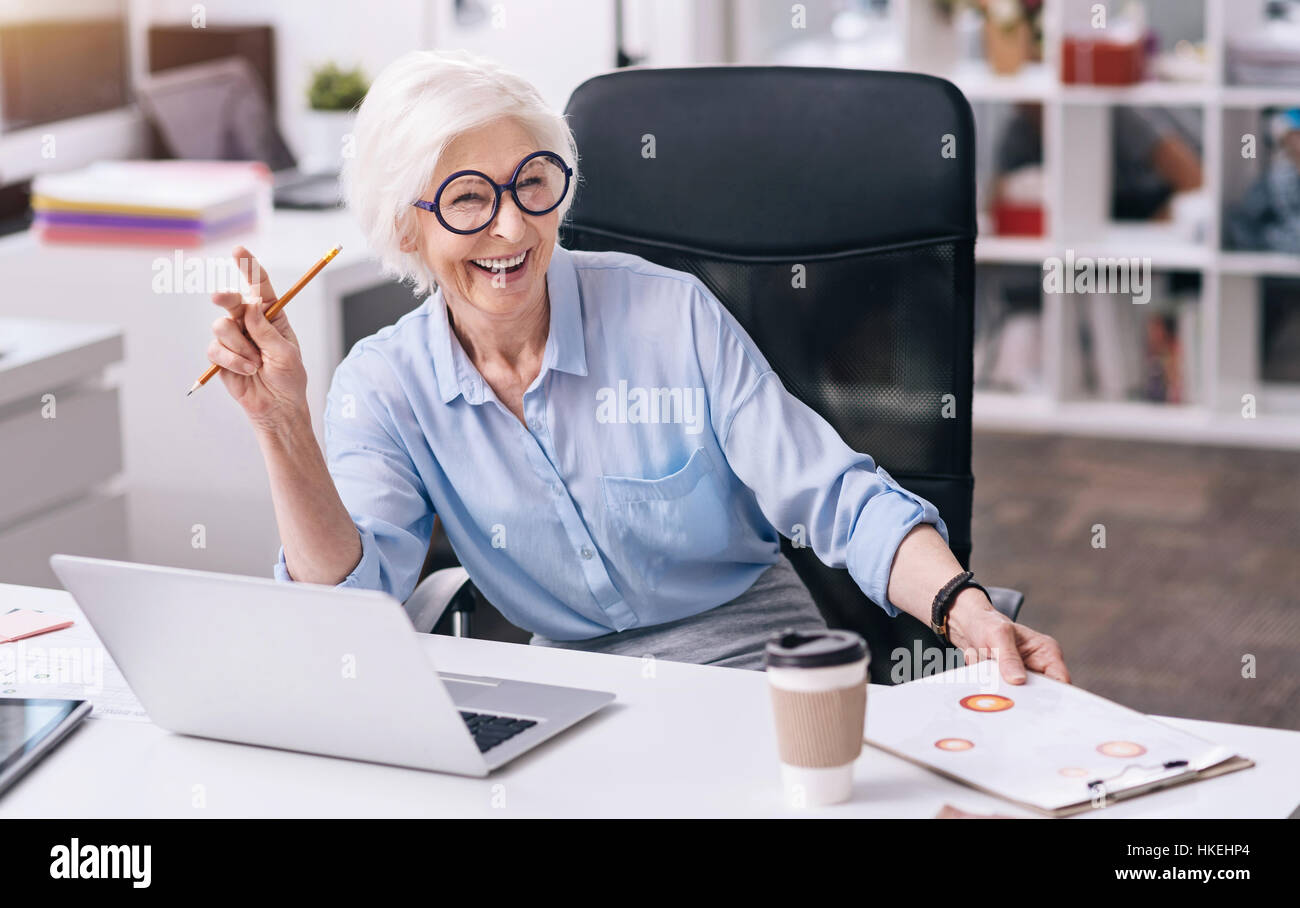 Laughing aged woman enjoying her job Stock Photo - Alamy