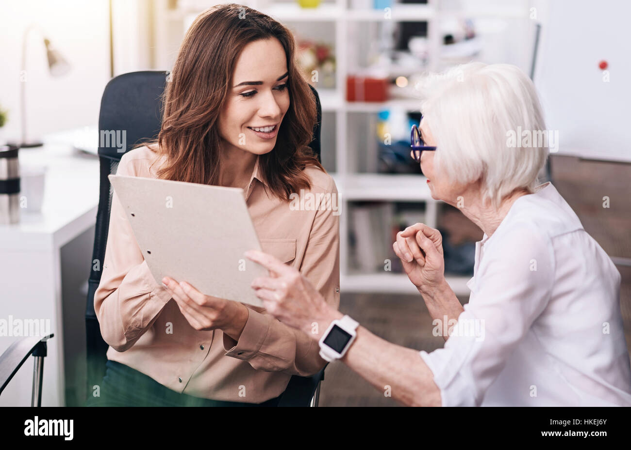 Positive business partners sharing ideas at work Stock Photo - Alamy