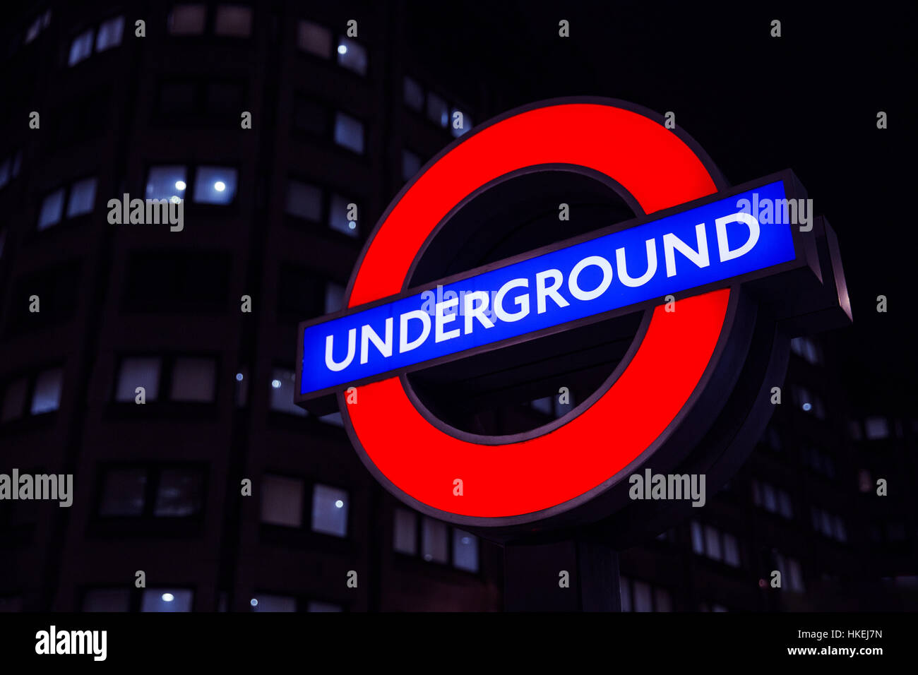 London Underground train station sign at night with lights on Stock ...