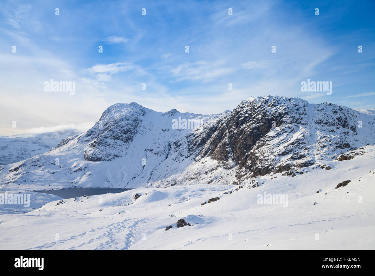The Langdale Pikes and Stickle Tarn covered in snow the Lake District ...