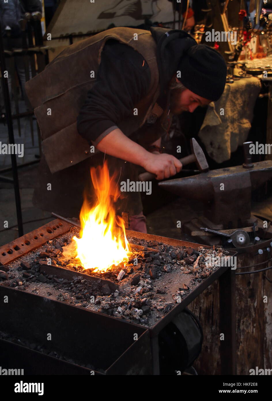 Blacksmith at work at his forge image in portrait format Stock Photo ...
