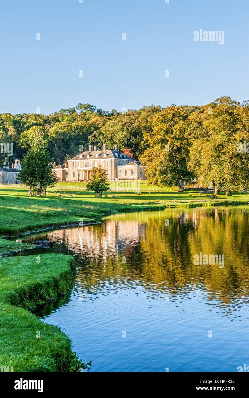 An English country house set in parkland with a lake Stock Photo - Alamy