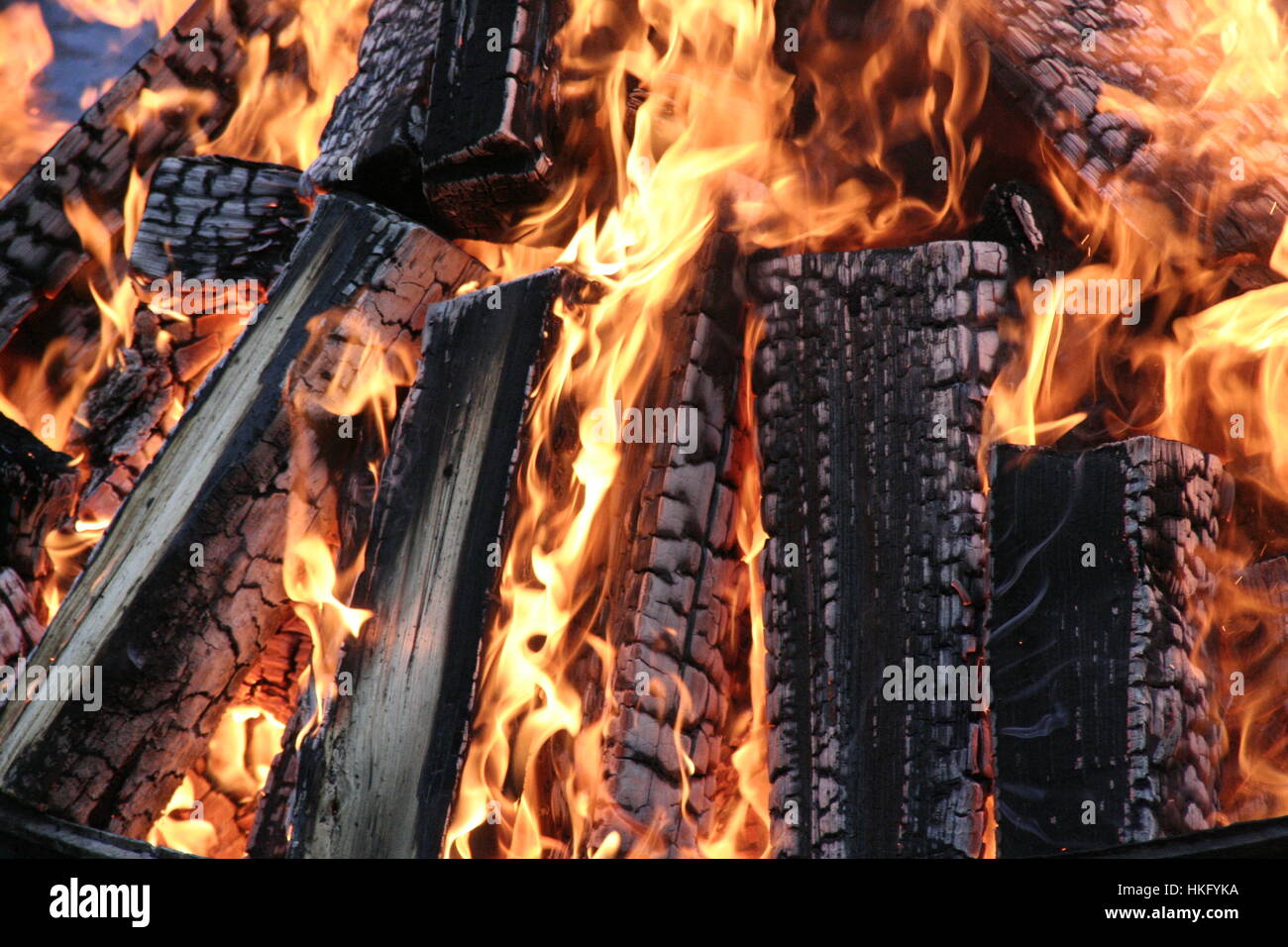 burning logs burned in the fire - background Stock Photo - Alamy