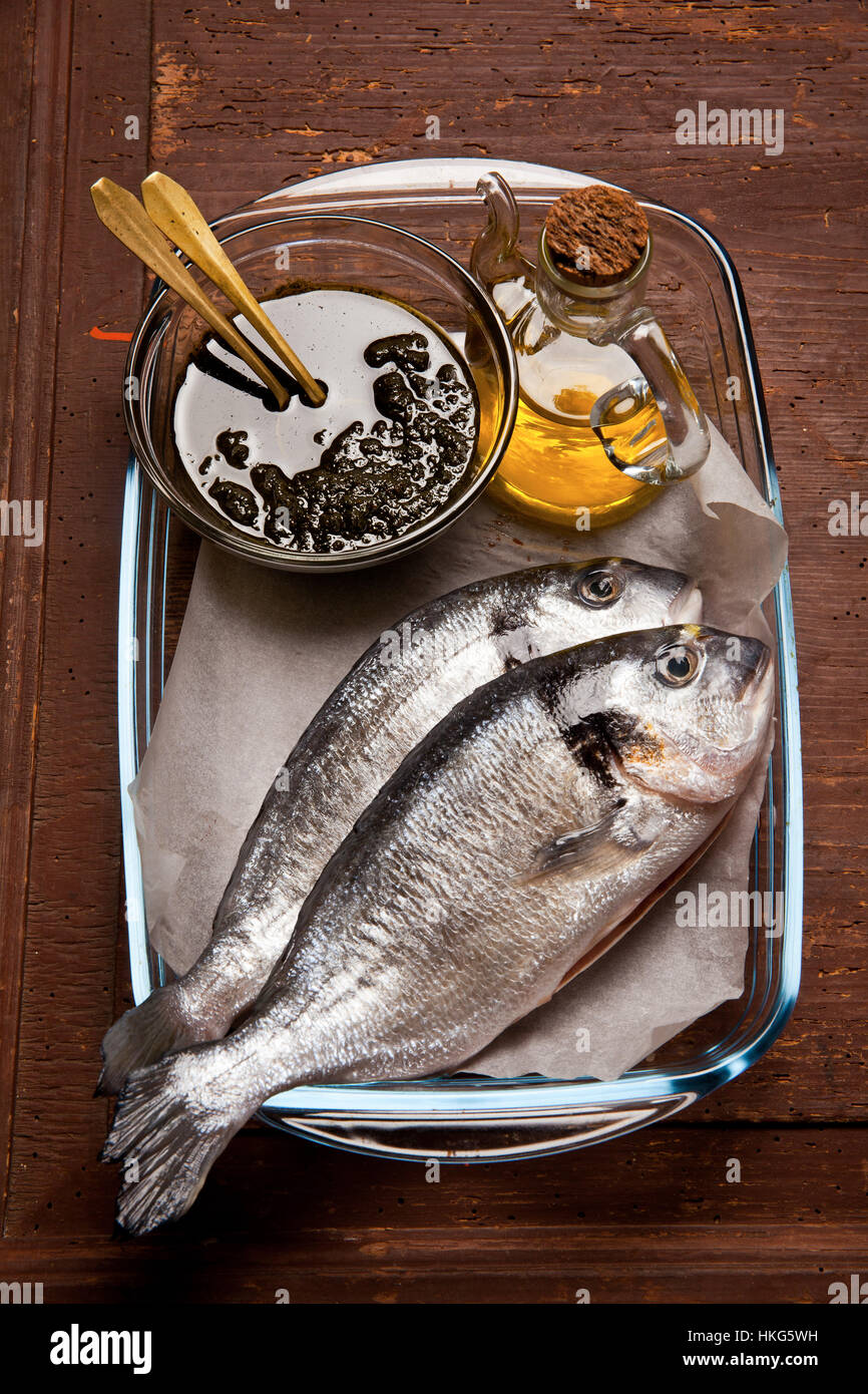 raw sea bream with homemade italian pesto ready to be put in the oven ...