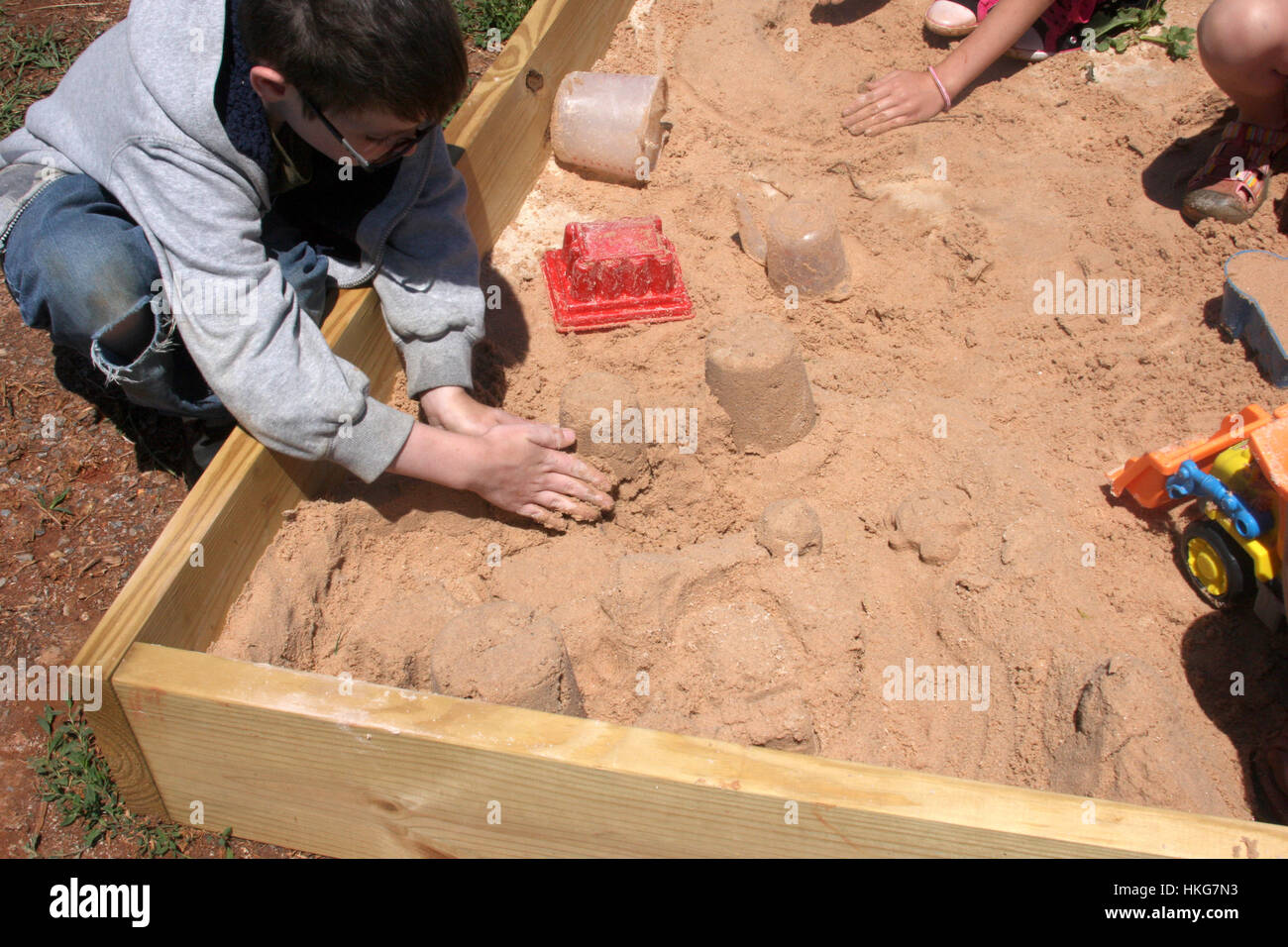 Children playing at sand box Stock Photo - Alamy