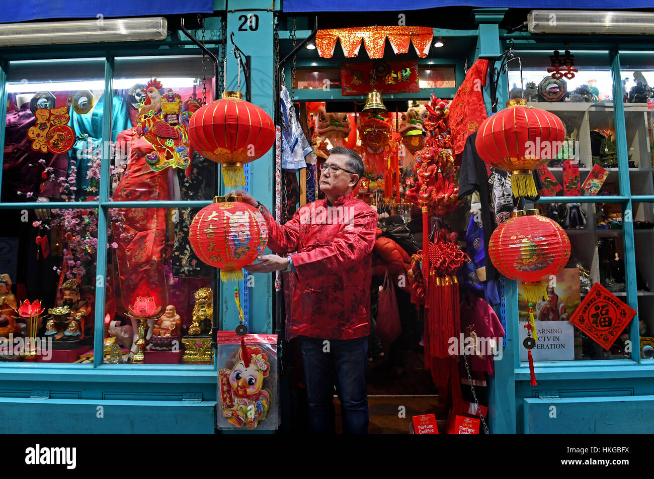 John Leung arranges decorations outside his shop on Little Newport ...