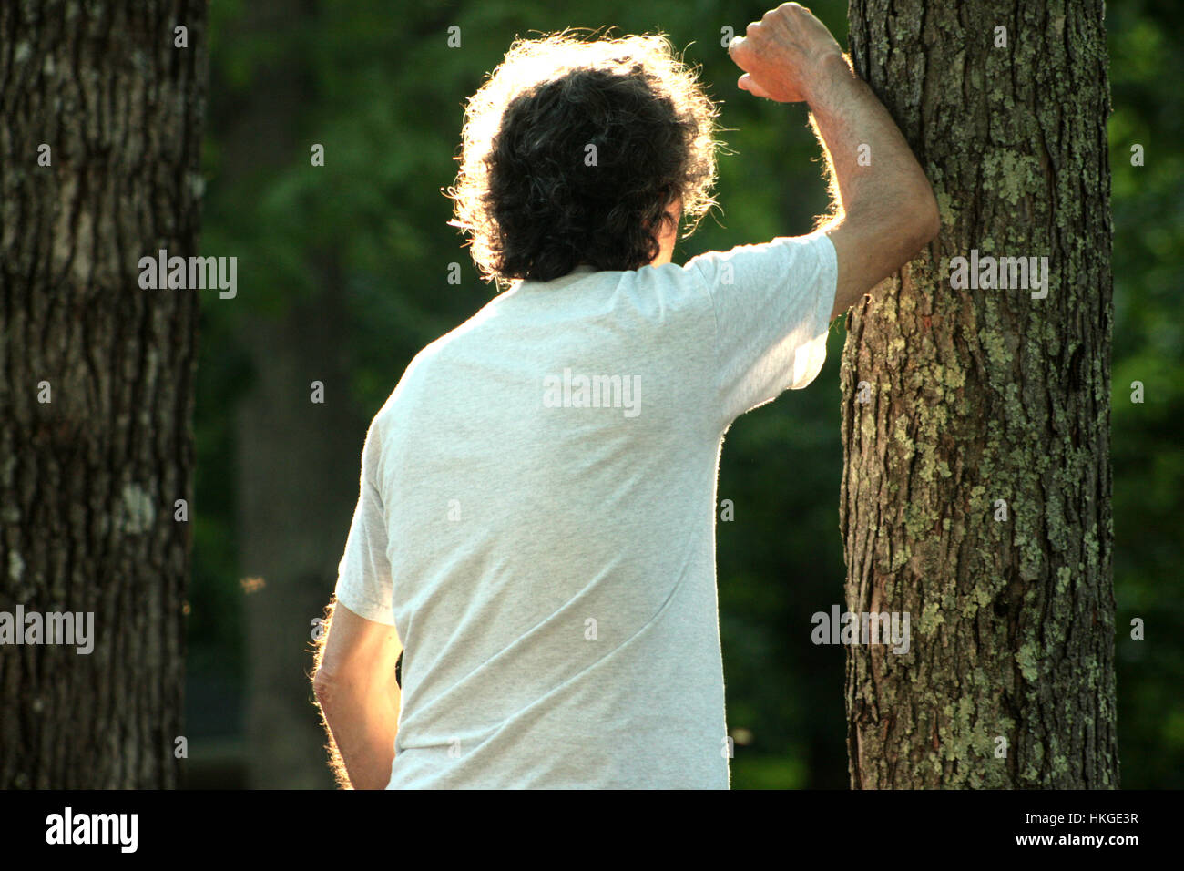 Back view of man alone outside, looking away Stock Photo - Alamy