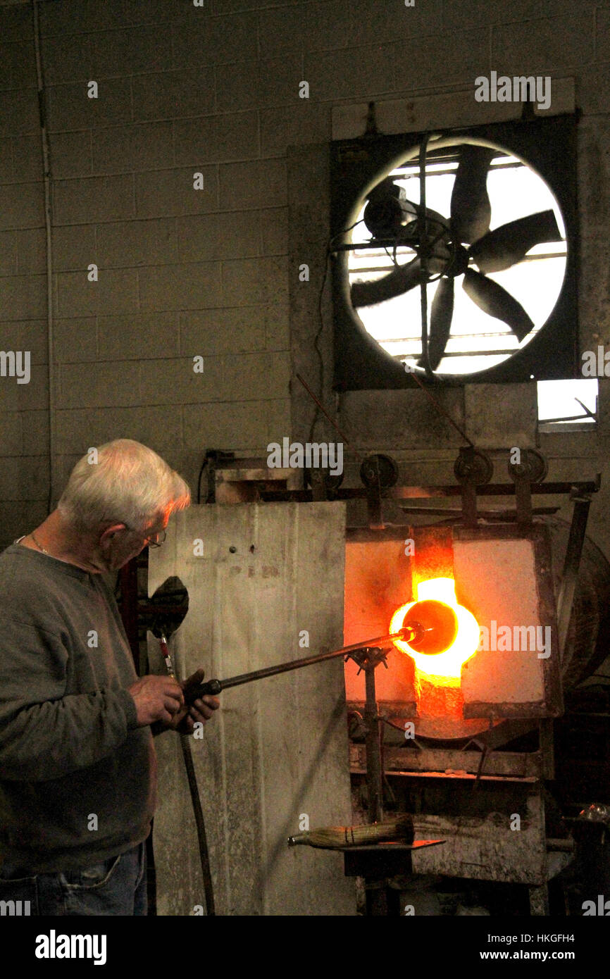 Man working in glass making workshop Stock Photo - Alamy