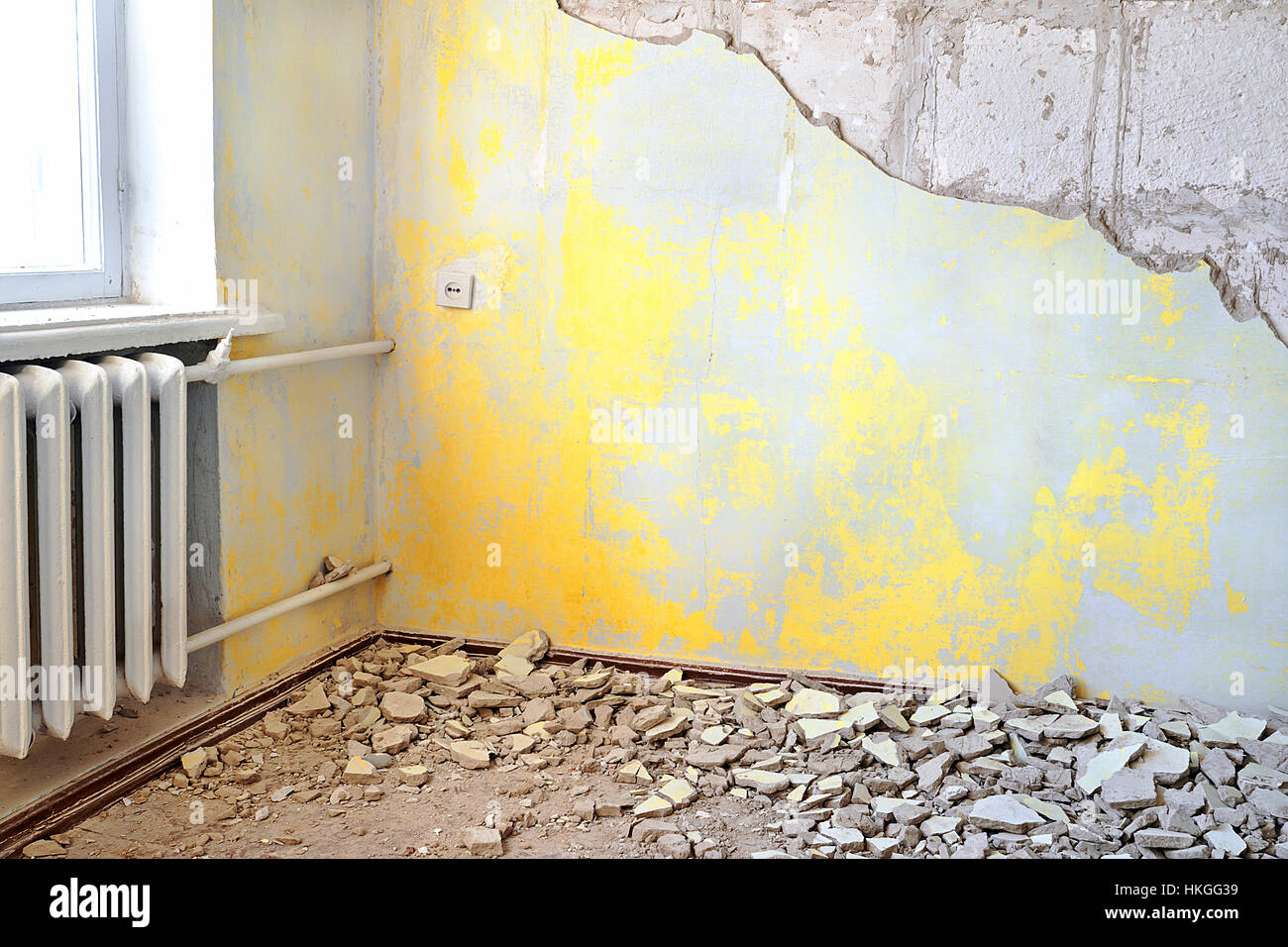 Destroyed dirty empty yellow interior with vintage radiator. Repair of ...