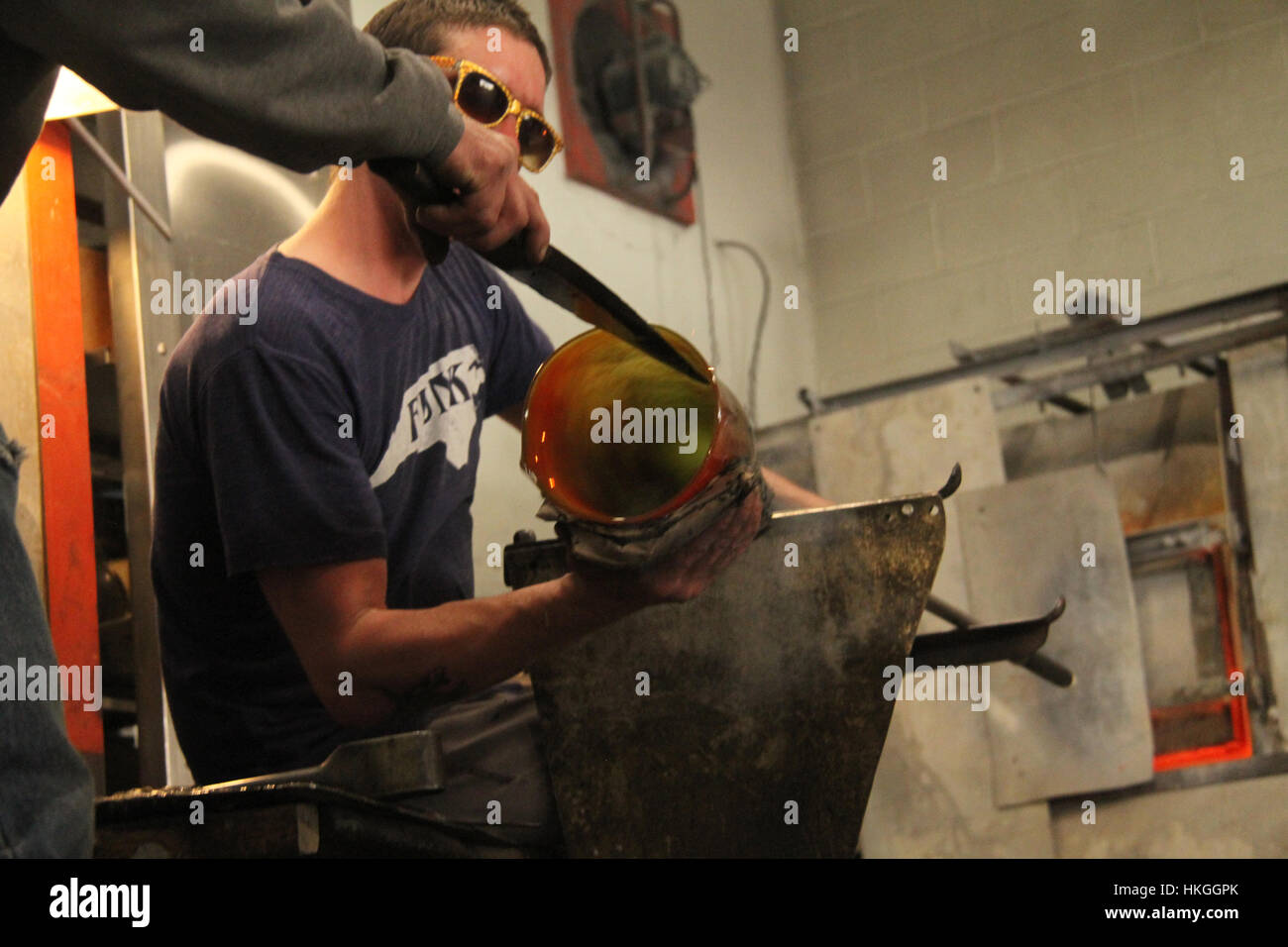 Man working in glass making workshop Stock Photo - Alamy