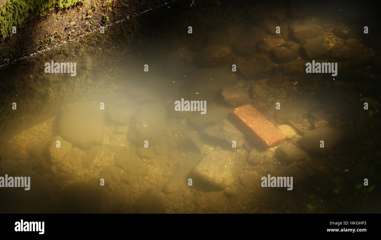 A brick submerged in water Stock Photo - Alamy