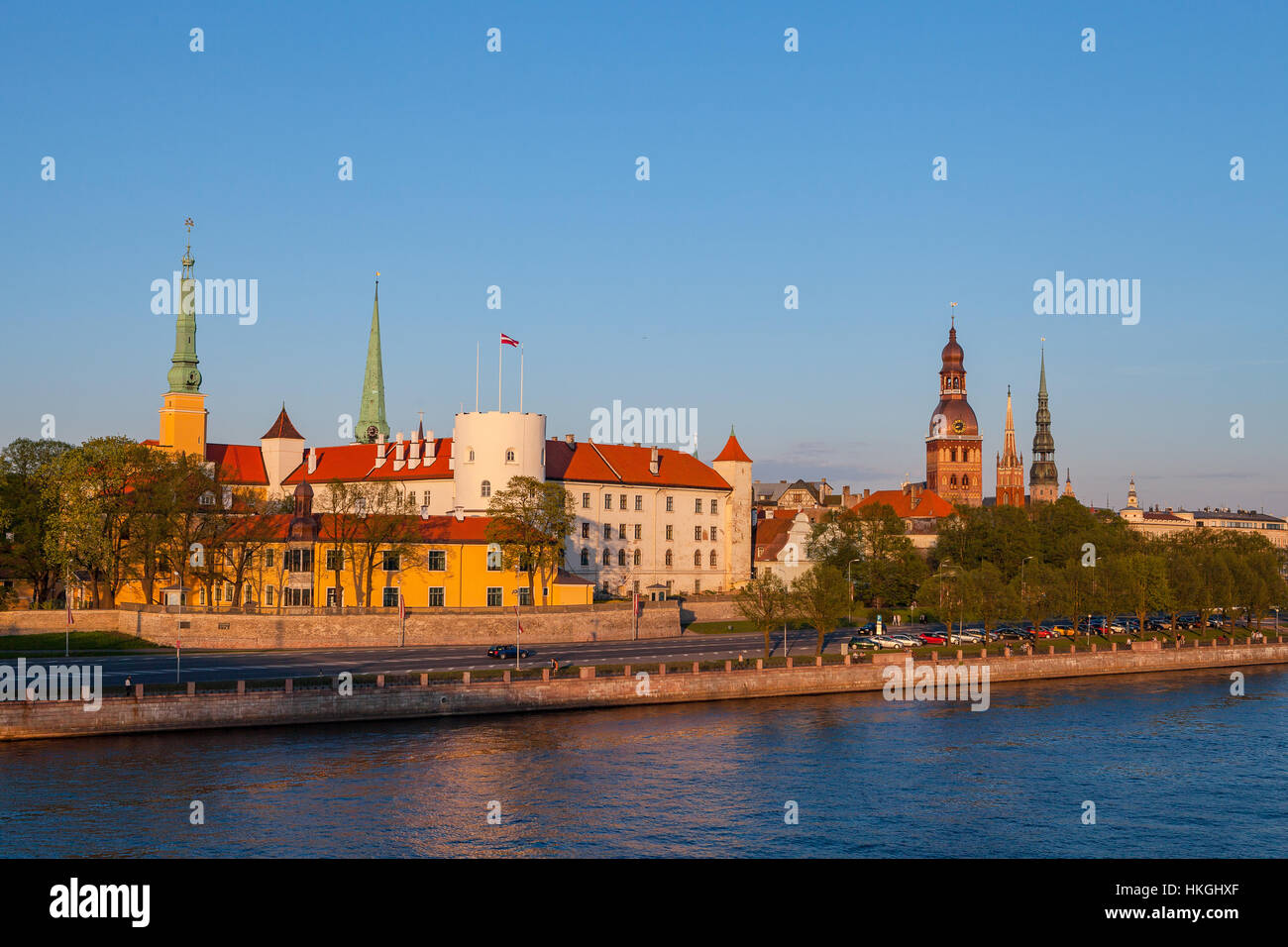 Old Riga castle at sunset. Waterfront of old town over Daugava River ...