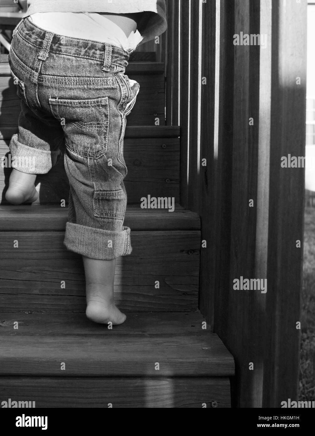 Baby walks up steps Stock Photo - Alamy