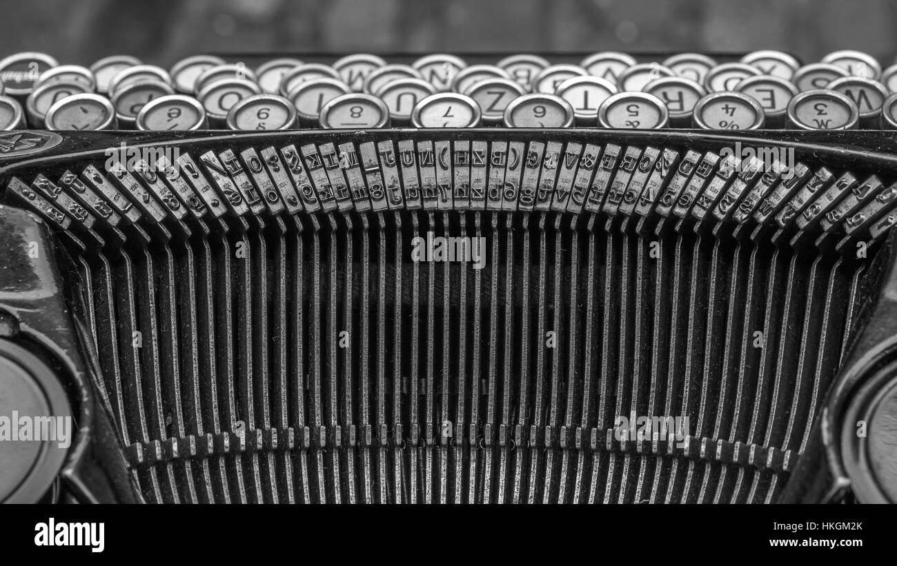 A vintage style mechanical typewriter with keys and type characters ...