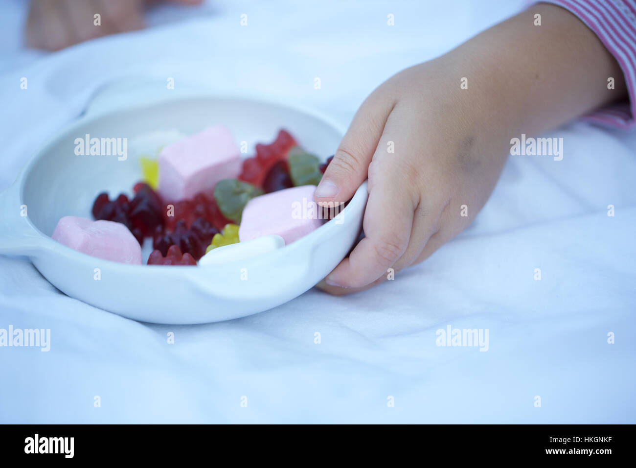Hand holding candy hi-res stock photography and images - Alamy