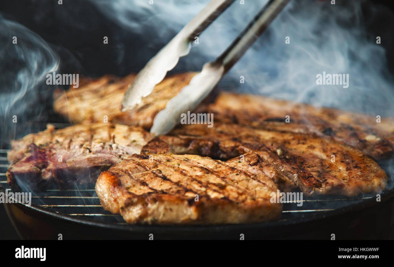 Baking fresh meat on grill closeup Stock Photo - Alamy