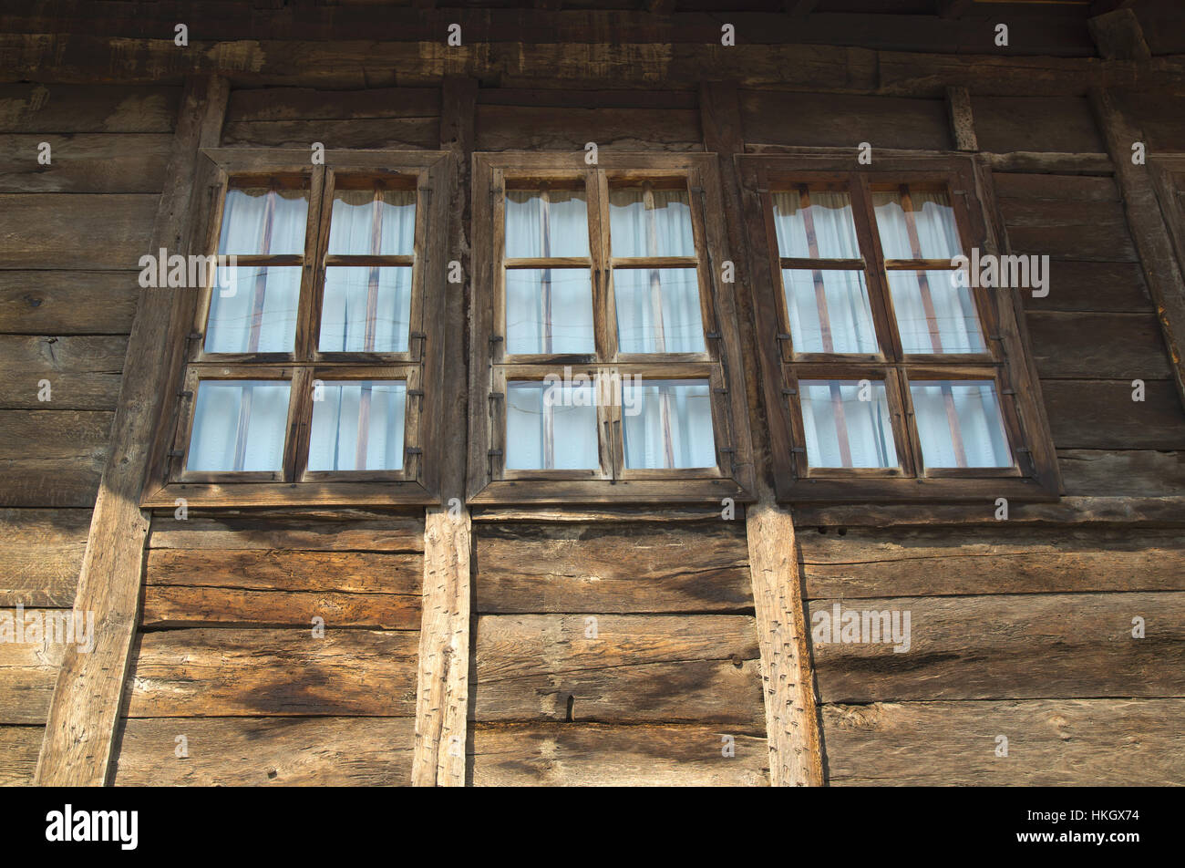 Stylish windows on wooden house Stock Photo - Alamy