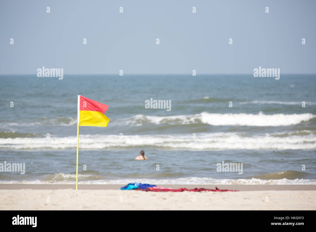 woman bathing at beach. flag, horizon, holiday, sea Stock Photo - Alamy