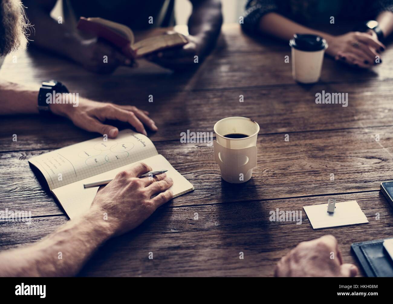 Diverse people teamwork on meeting table Stock Photo - Alamy