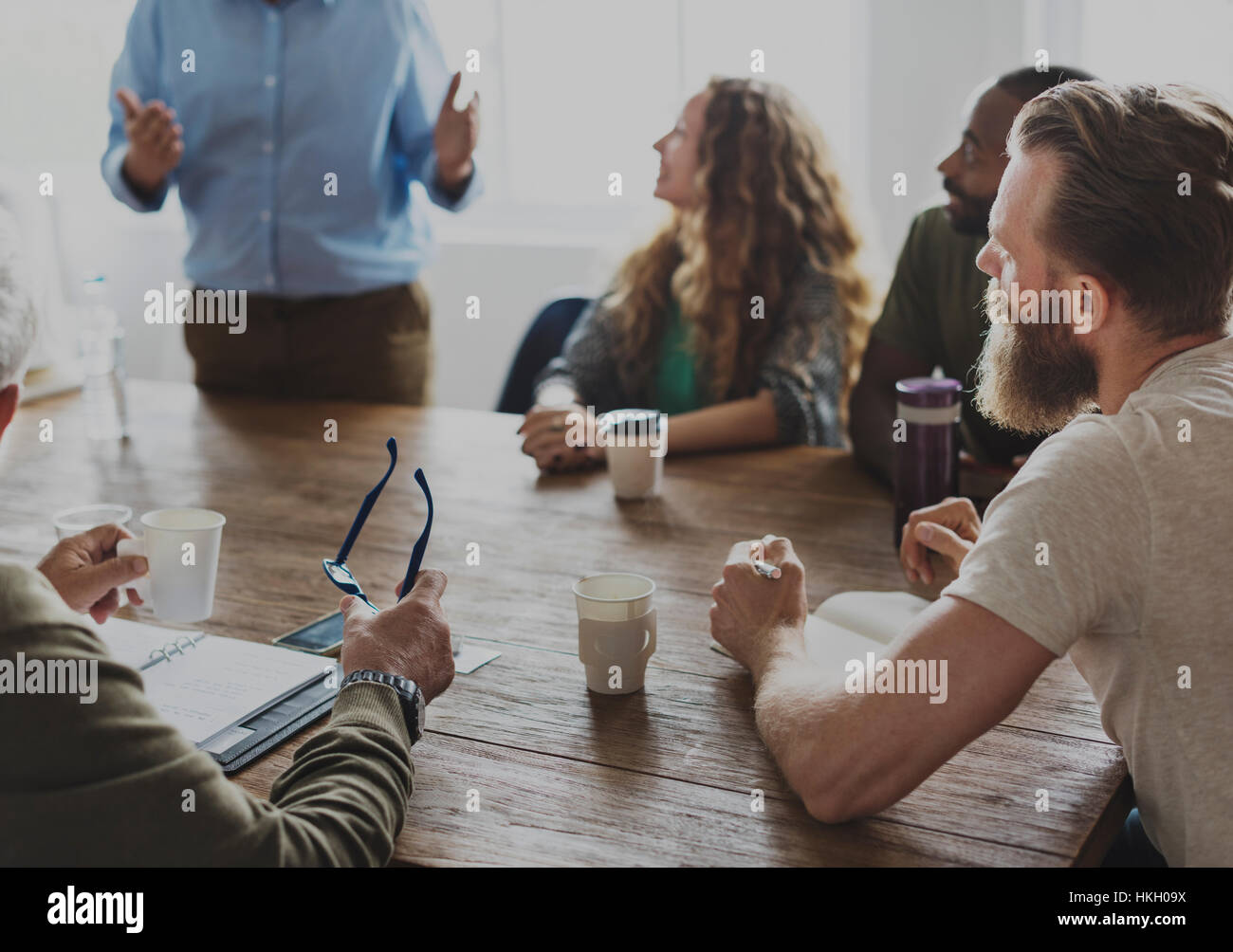 Diverse people teamwork on meeting table Stock Photo - Alamy