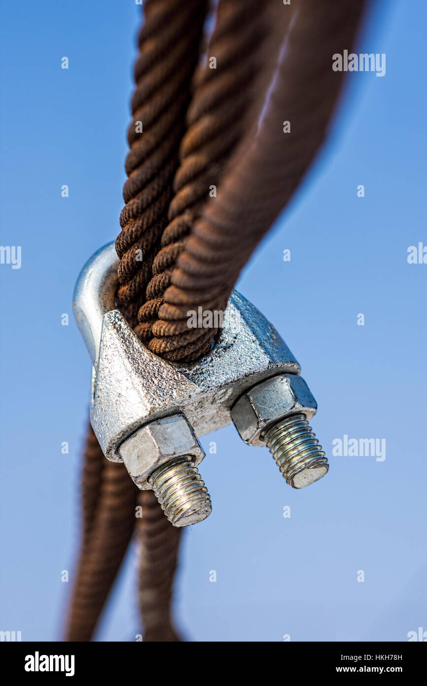 Rusty Steel Ropes with Shiny U-Bolt Clamp on Blue Sky Background ...