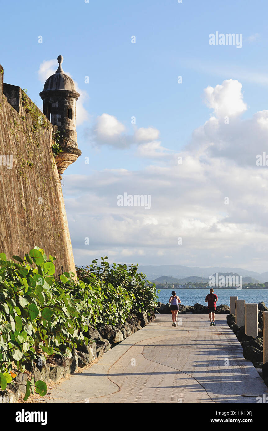 People run next to castle in puerto rico Stock Photo - Alamy