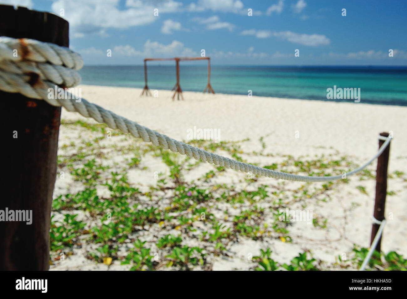 Fence from white rope on blue beach Stock Photo - Alamy