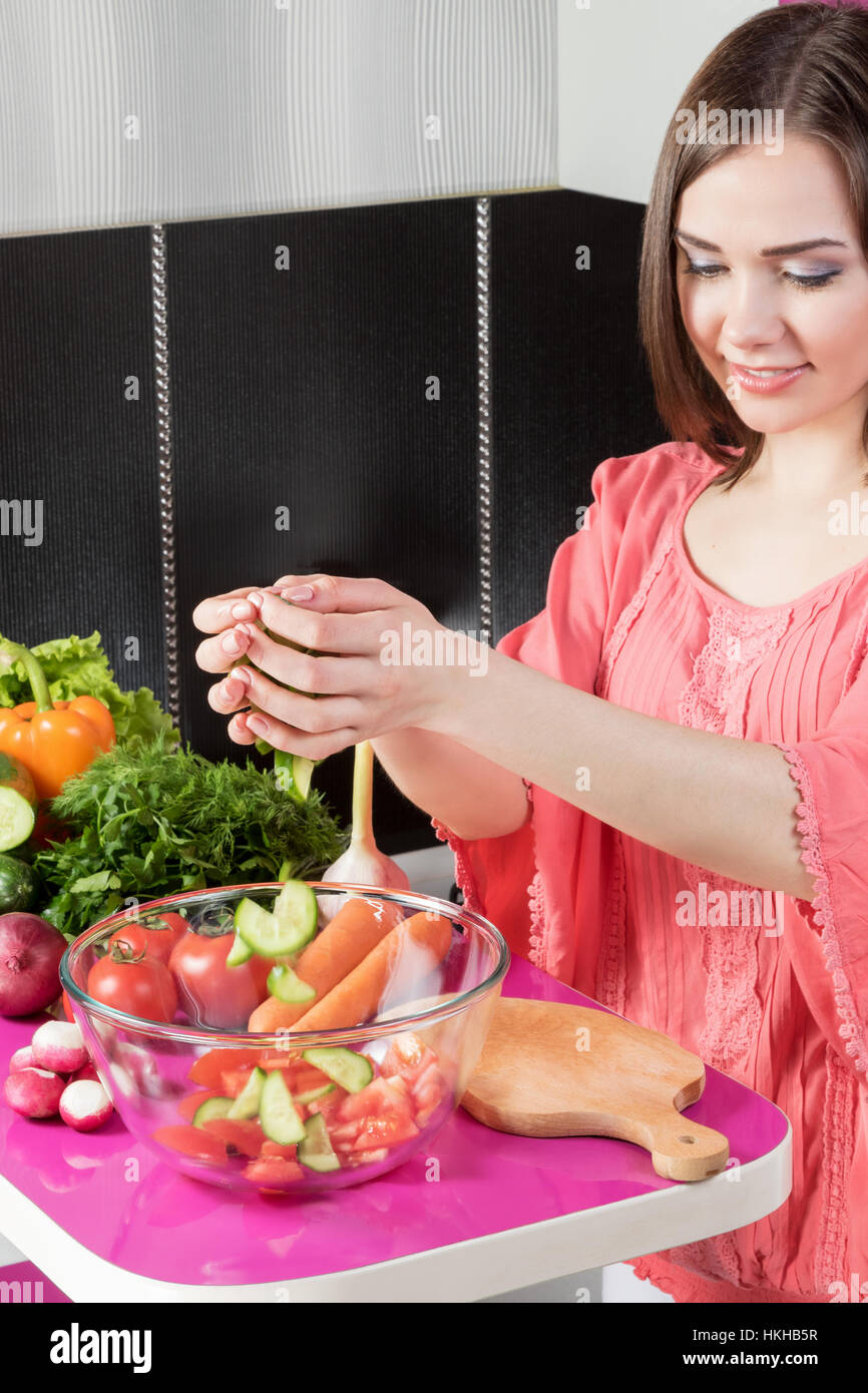 Woman making salad Stock Photo - Alamy