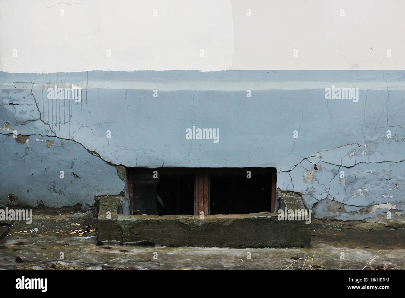 window with broken glass in a basement in an old house with destroyed ...