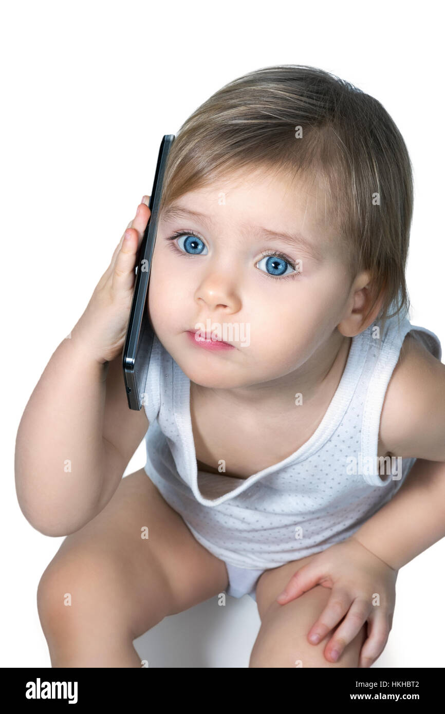Cute little girl is talking on smartphone Stock Photo - Alamy
