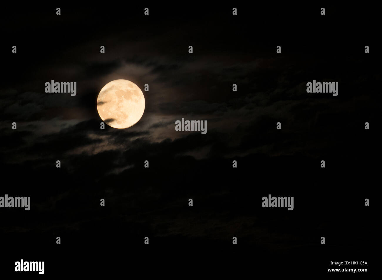 Super bright full moon and partially covered with dramatic black sky ...