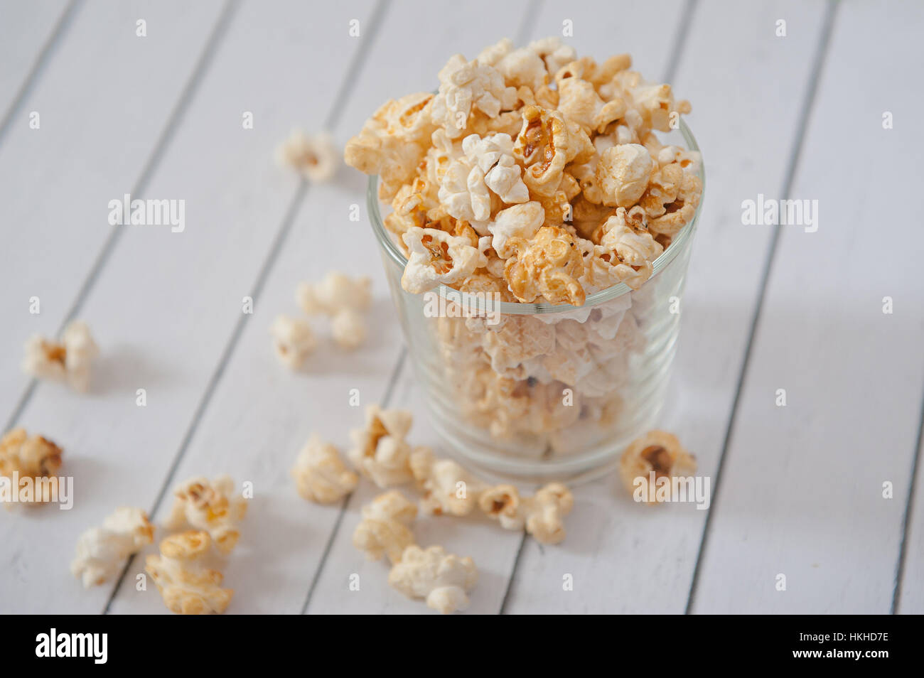 Popcorn in glass cup on white background Stock Photo - Alamy
